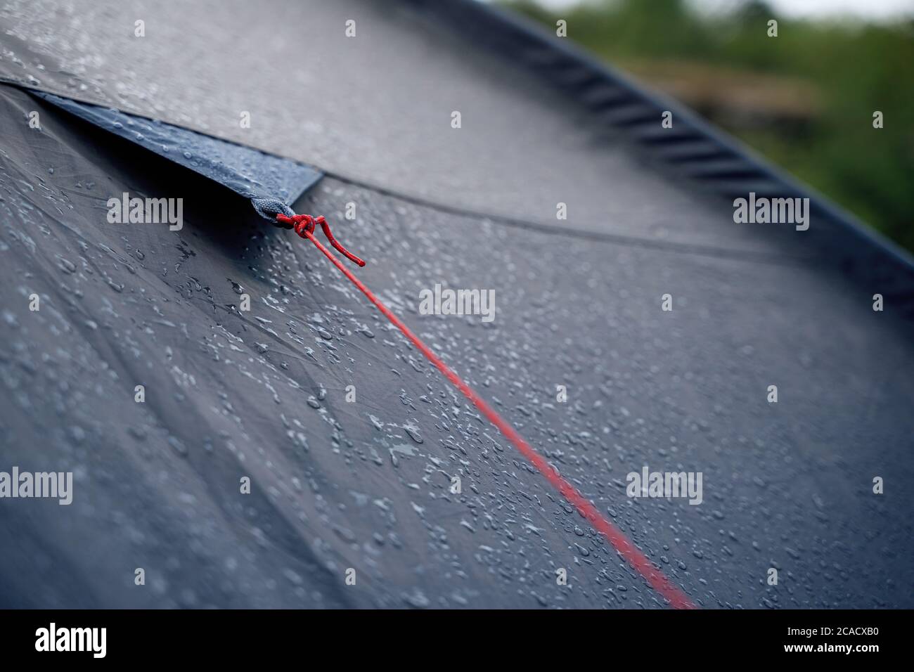 closeup detail perspective view of anchoring red rope on dark blue ...