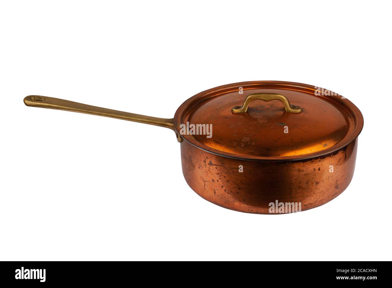 side view closeup of old cooking pan with copper lid and metallic ...