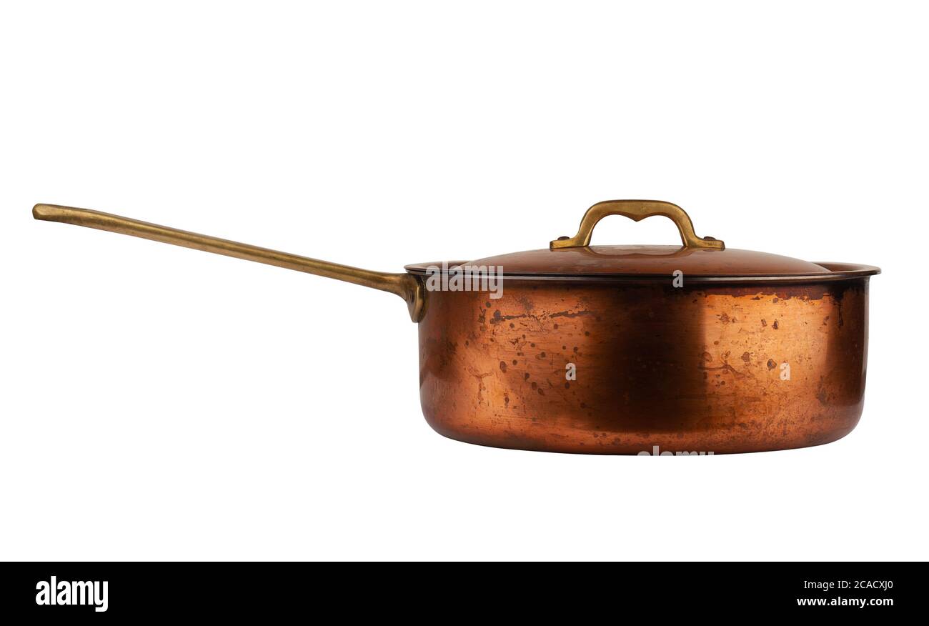 side view closeup of old cooking pan with copper lid and metallic ...