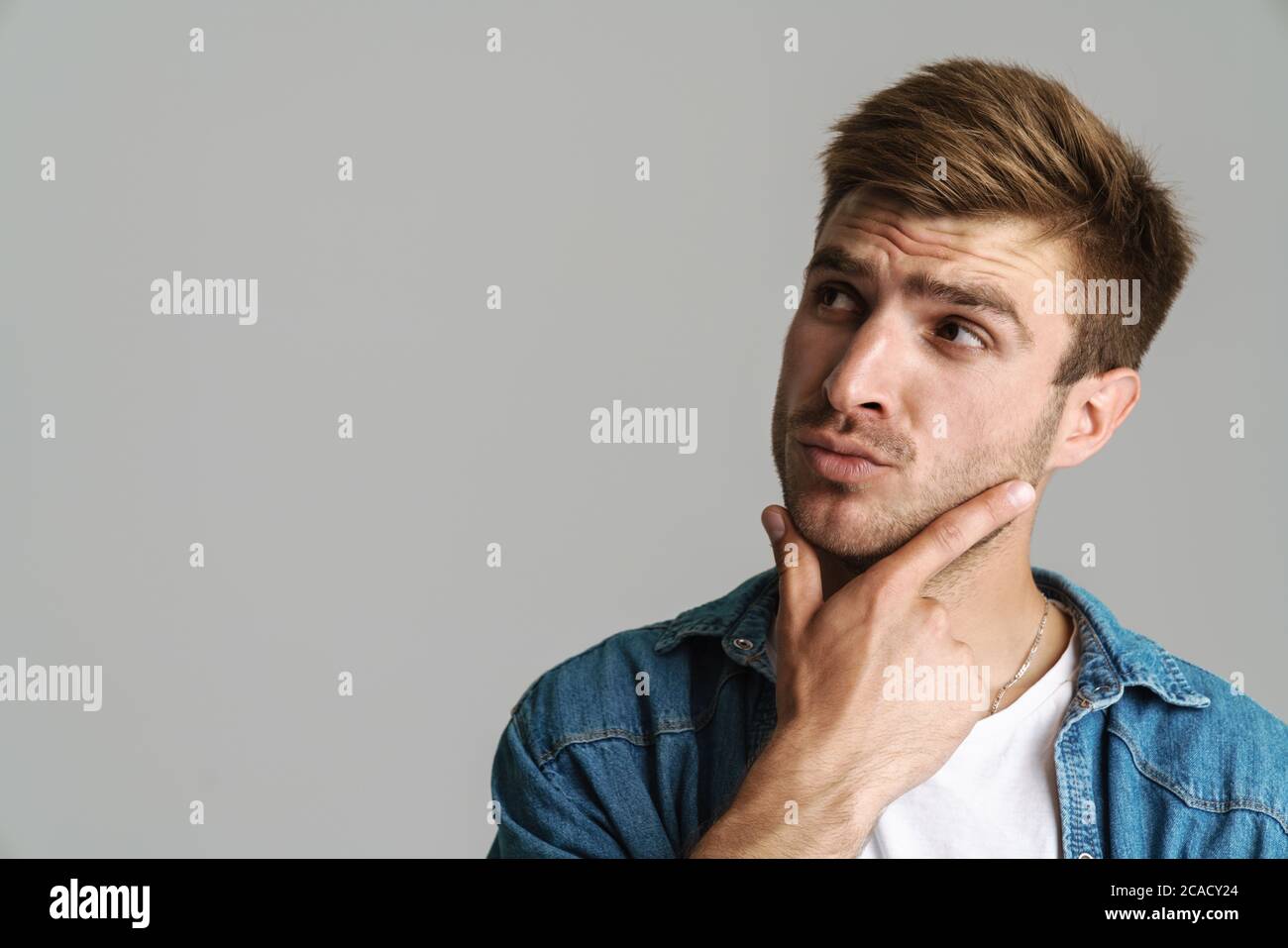 Portrait of redhead puzzled man posing and thinking at camera isolated ...