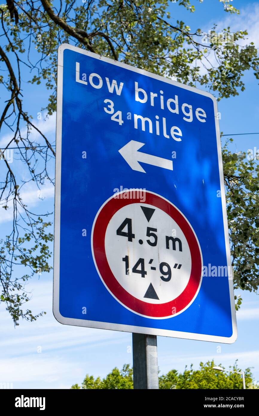 Sign with height restriction warning of low bridge ahead inUpton Wirral ...