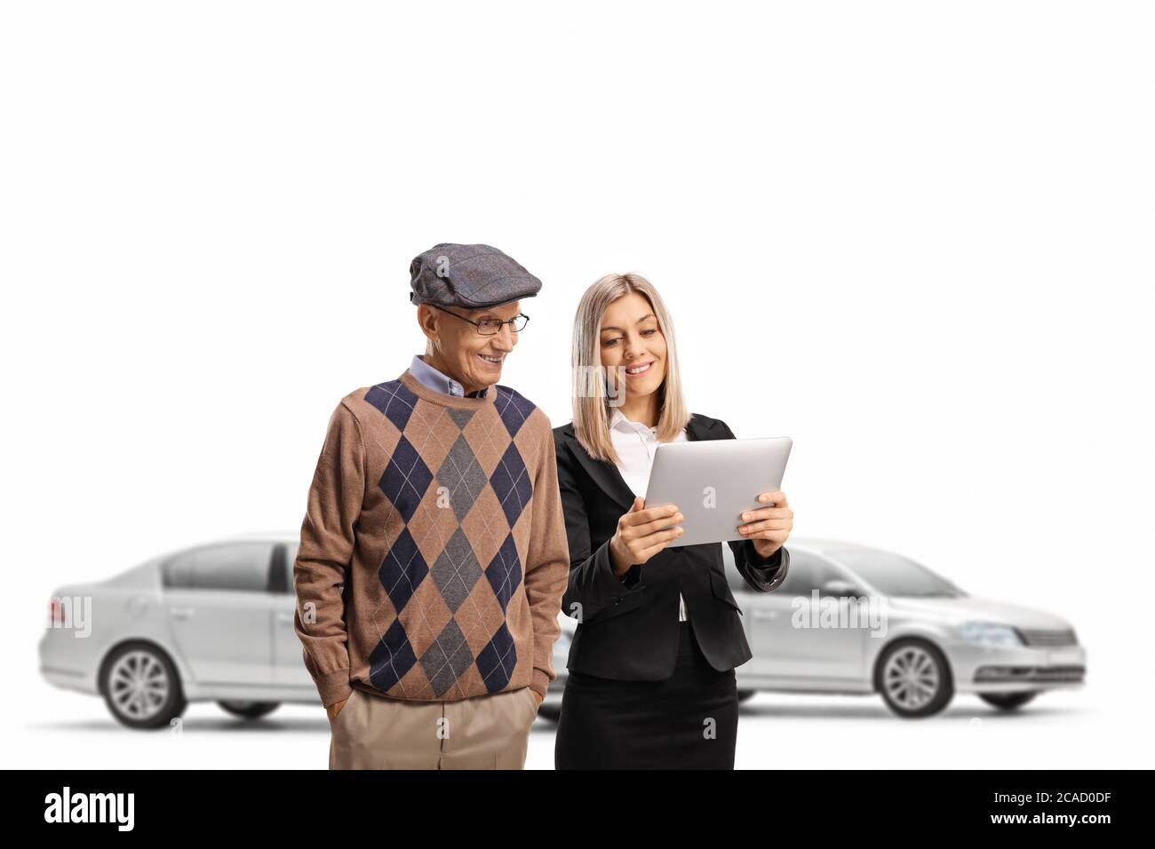 Car saleswoman showing a digital tablet to an elderly male customer ...