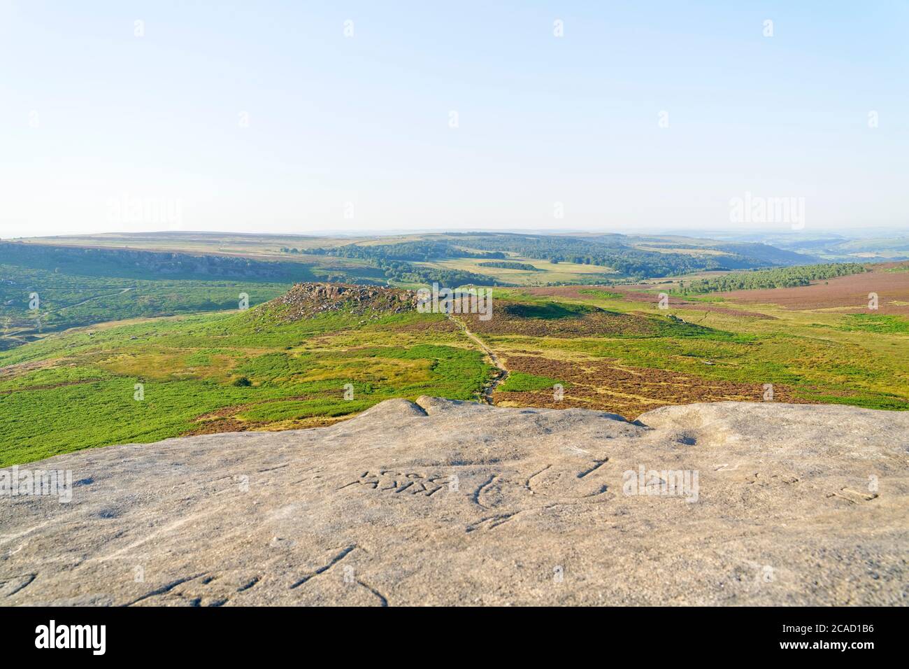 Over a flat gritstone rock on Higger Tor to the ancient Carl Wark ...