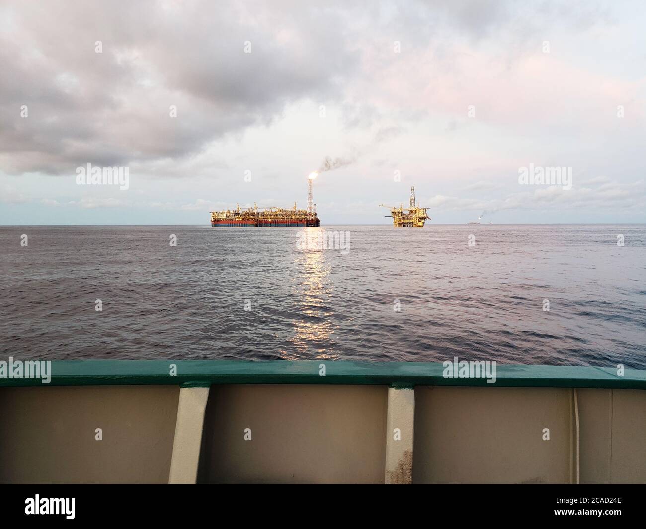 FPSO tanker vessel near Oil Rig platform. Offshore oil and gas industry ...