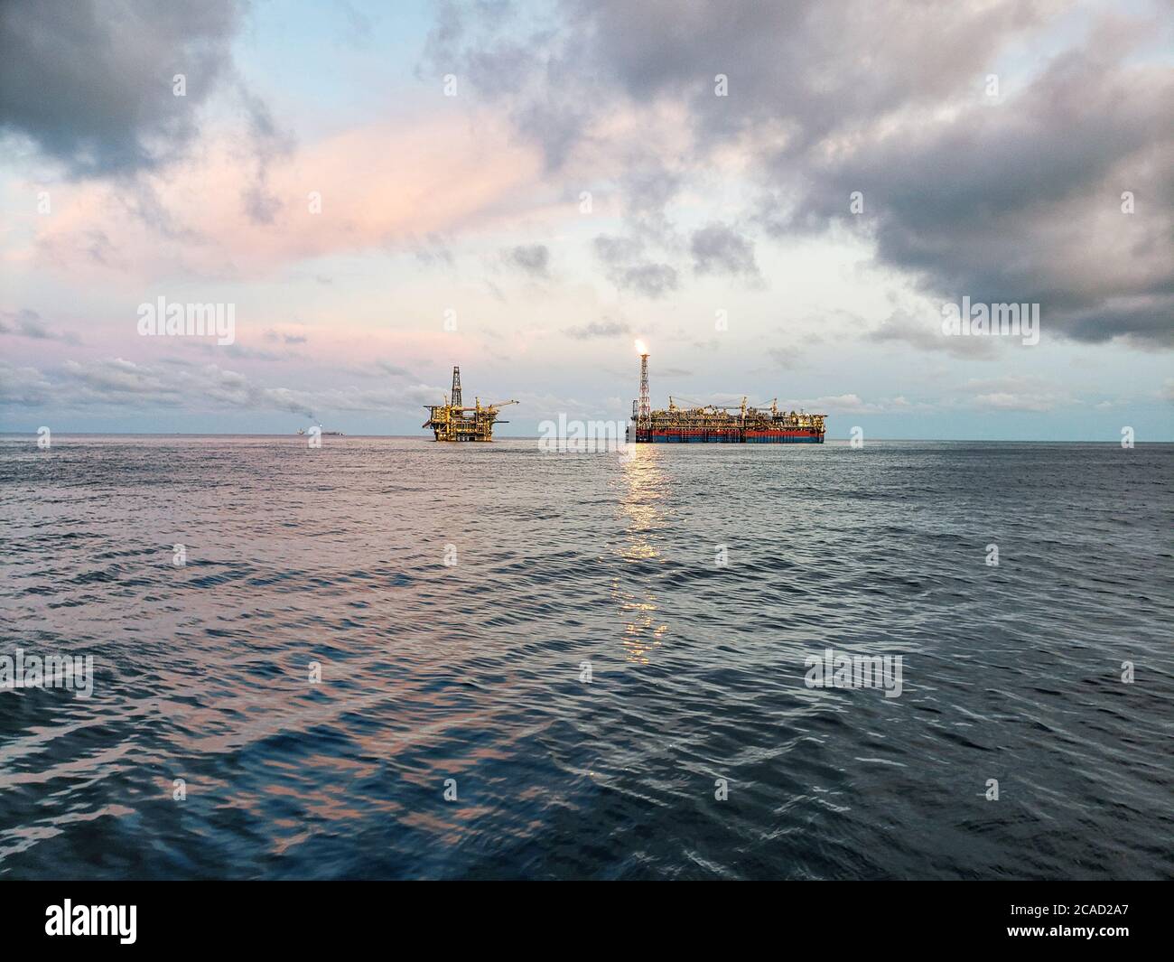 FPSO tanker vessel near Oil Rig platform. Offshore oil and gas industry ...