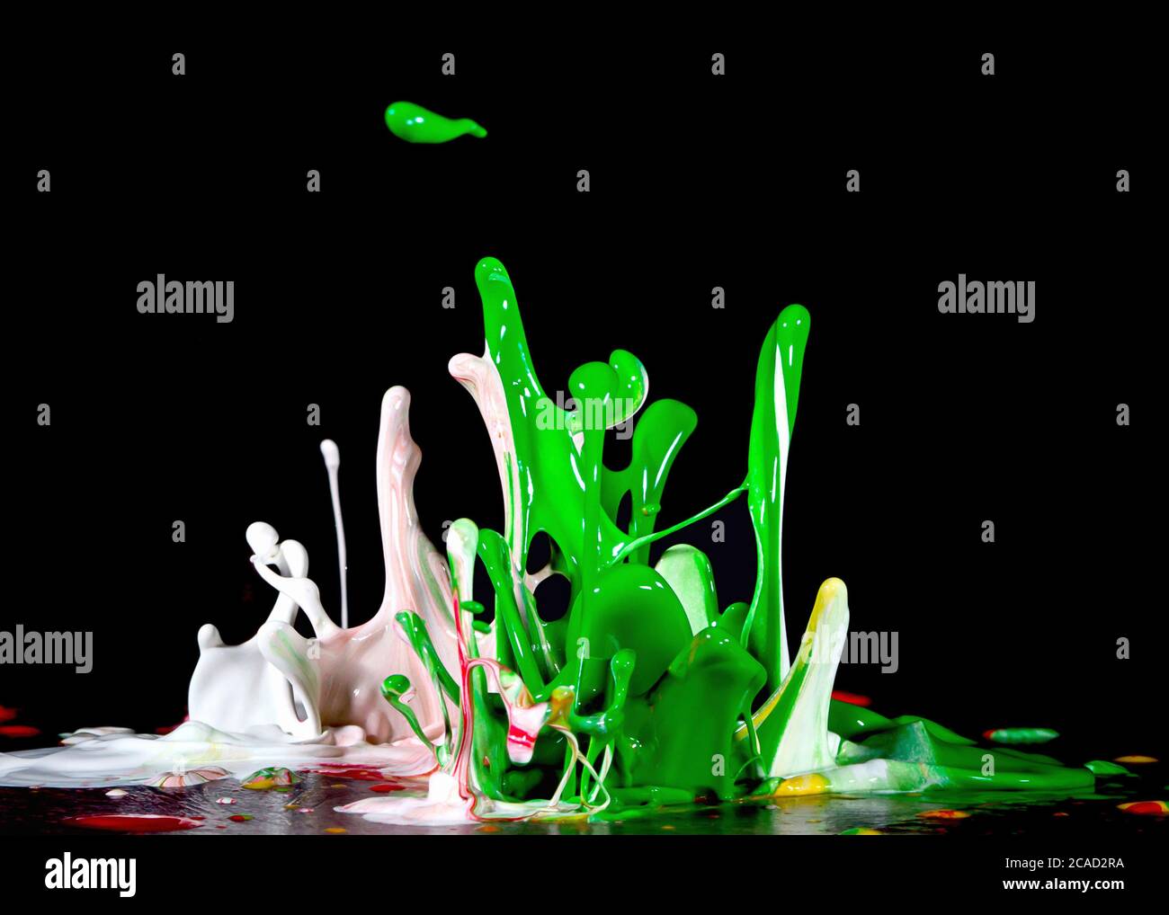 Explosion of multicolored paint caused by sound, on black background ...
