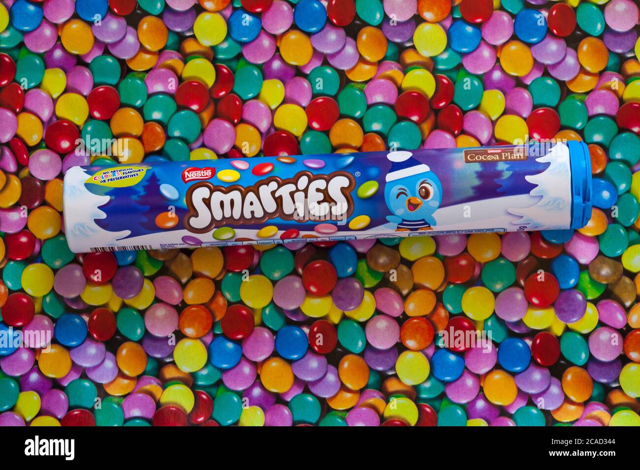 Nestle tube of Smarties set on colourful sweets background - candies ...