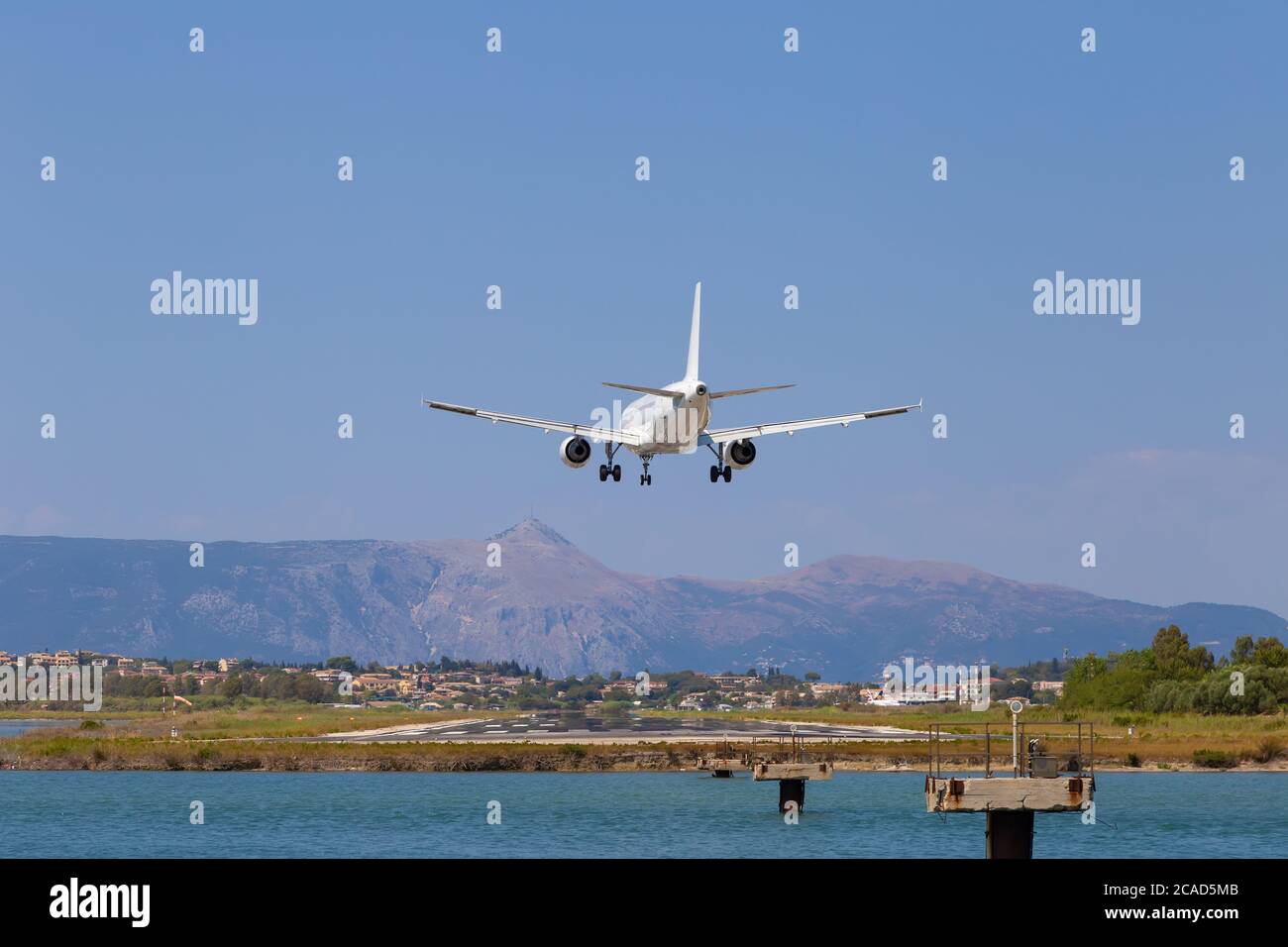 Airplane landing mountains on background hi-res stock photography and ...