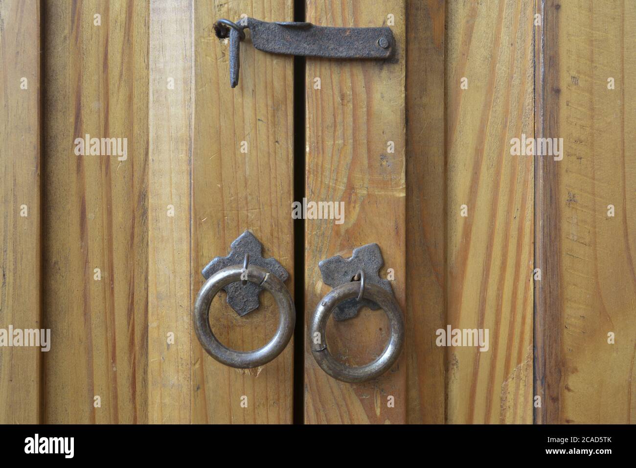 Front view of round decorative metal handles on a wooden door Stock ...