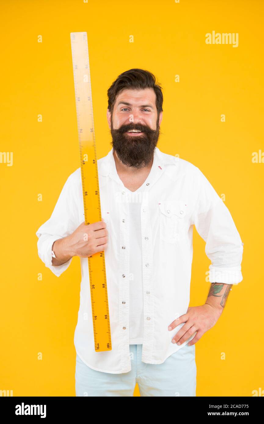 Man bearded hipster holding ruler. Measure length. Size tall and length ...