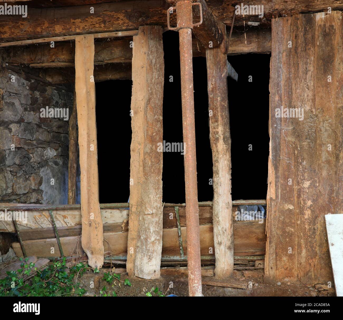 dark entrance of the abandoned mine crumbling with the boards of rotten ...