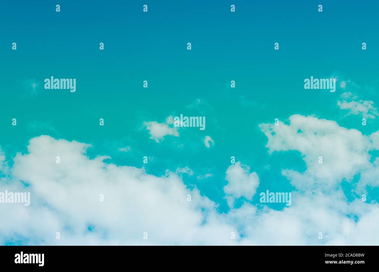 Blue sky as a background, with soft and blurry clouds, scattered Stock Photo - Alamy