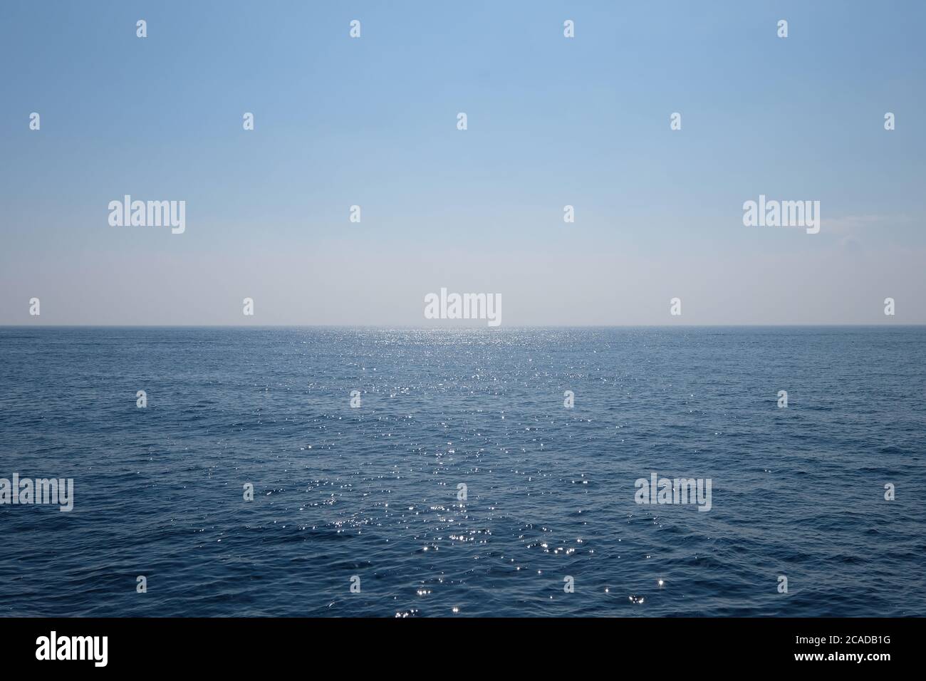 wide deep blue sea horizon. peaceful ocean surface with sunlight ...