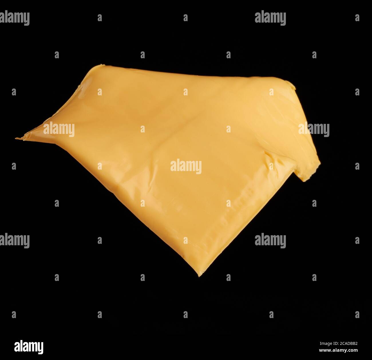 square piece of cheddar cheese isolated on black background ...