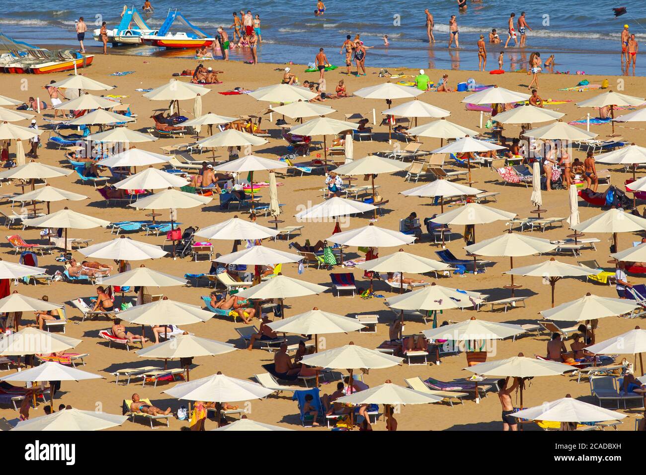 Crowded beach covered with sun umbrellas Stock Photo - Alamy