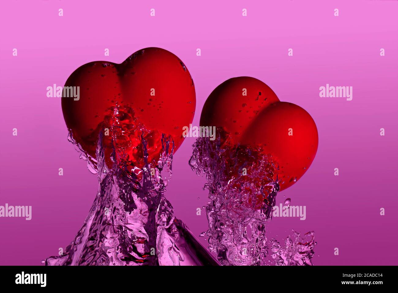 Red hearts rising in water in a splash on pink background Stock Photo ...
