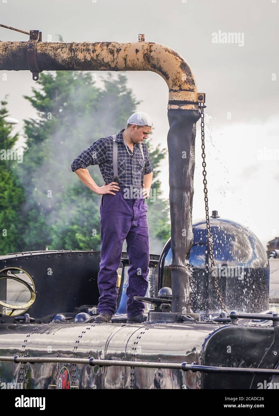 Steam locomotive crew fireman standing on vintage steam engine as it ...