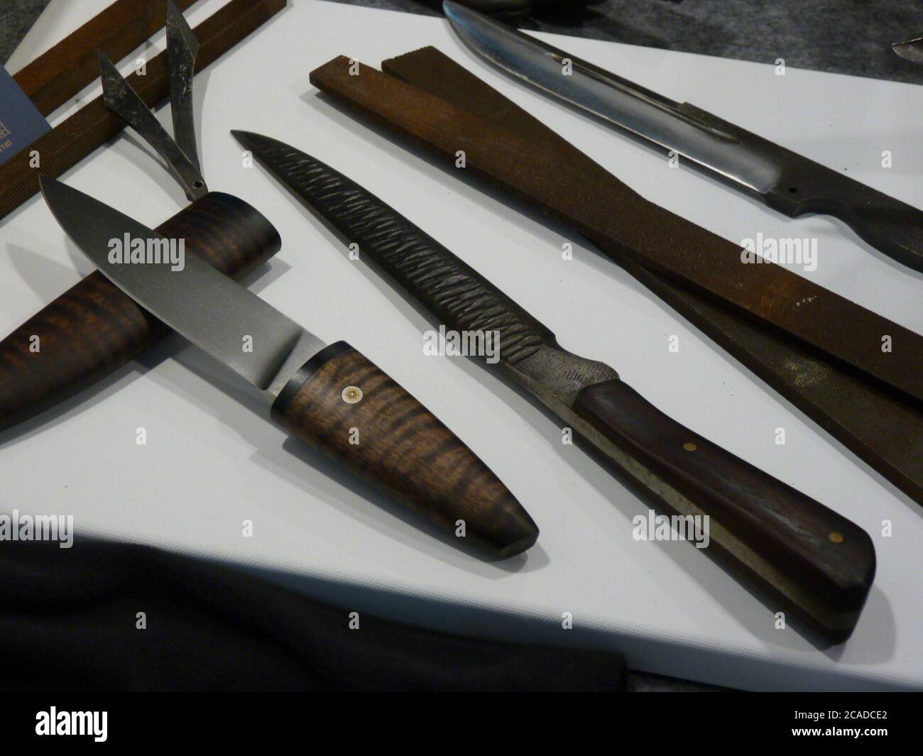 Closeup of long different machetes and iron bars on a white table Stock ...