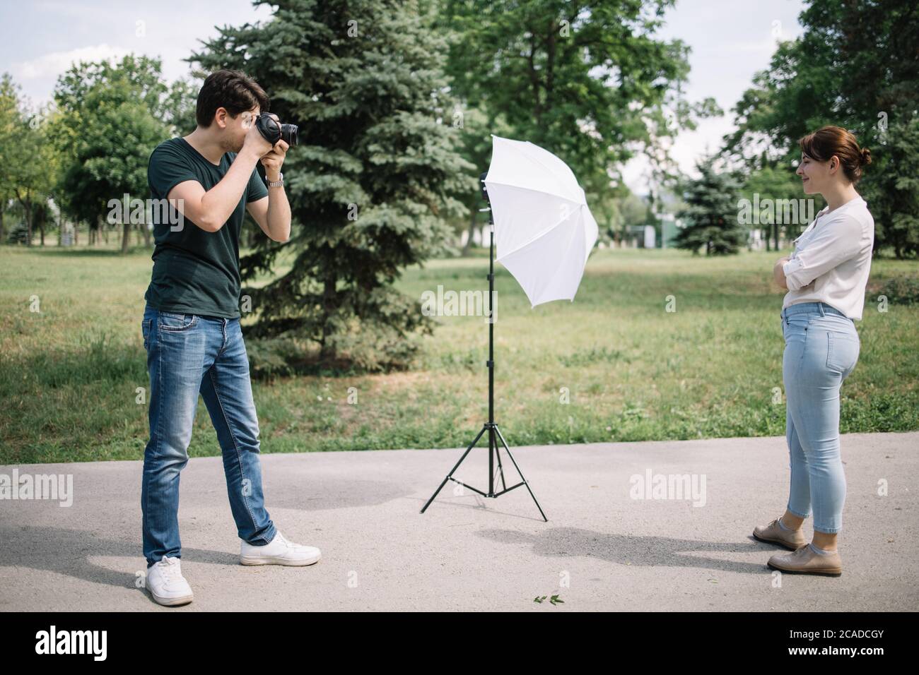 Side view of young man working with professional model Stock Photo - Alamy