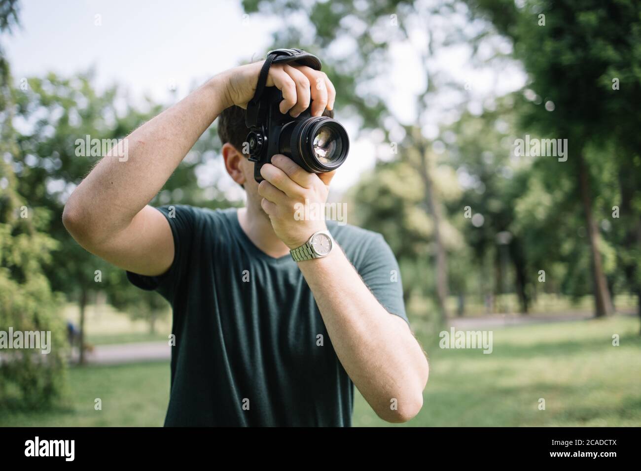 Front view of man taking photos in nature Stock Photo - Alamy