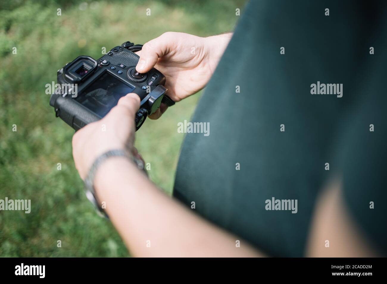 Close-up view of man hands holding camera and checking pictures Stock ...