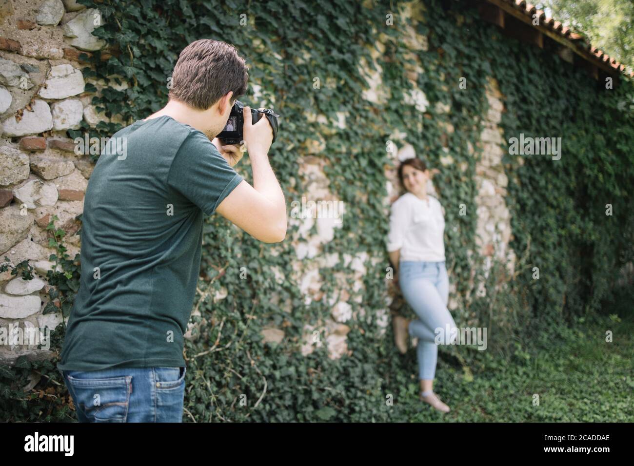 Out of focus woman having professional photo session from photographer ...