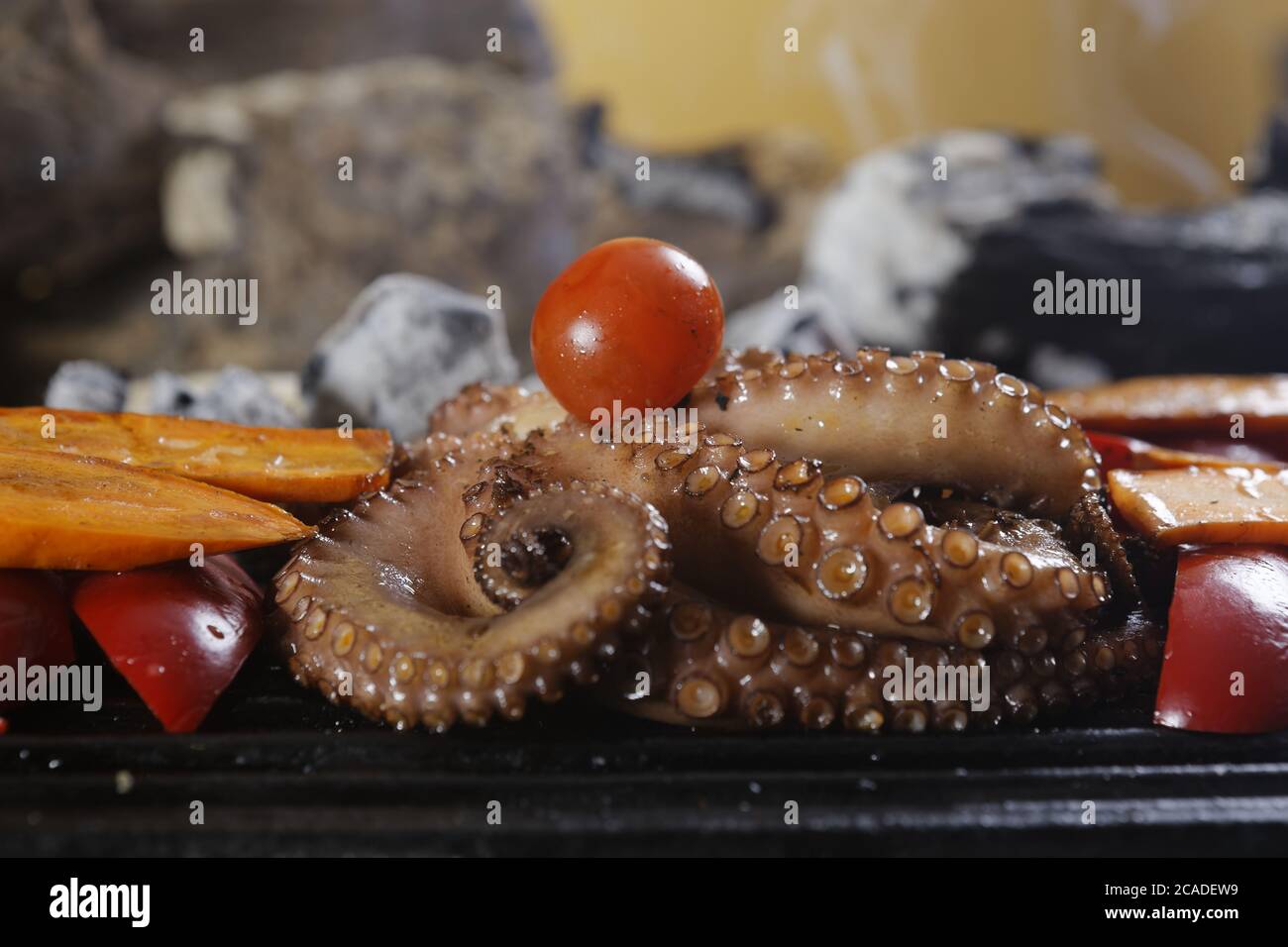 Closeup shot of cooked octopus legs and vegetables Stock Photo - Alamy