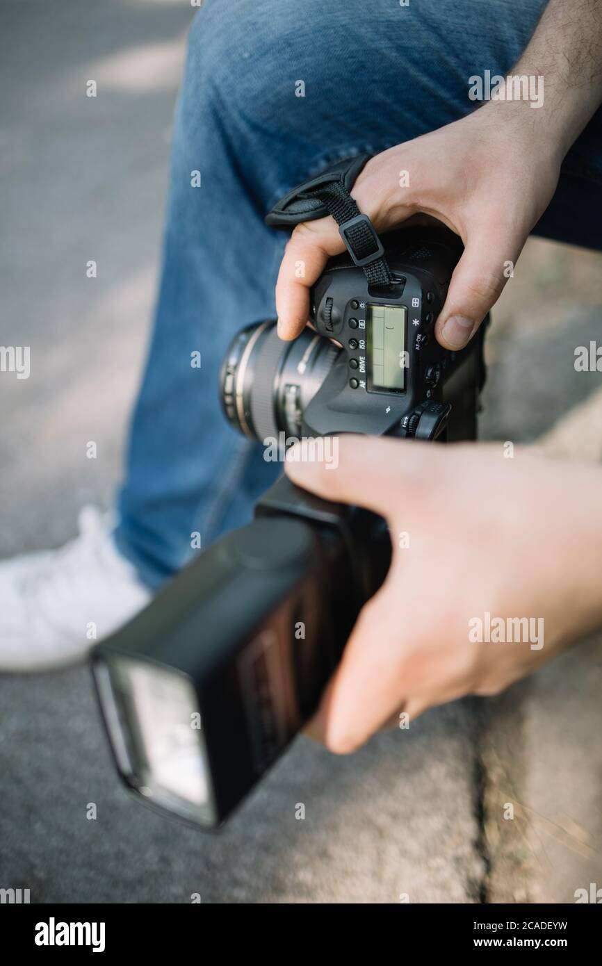 Male hand holding professional camera with flash Stock Photo - Alamy