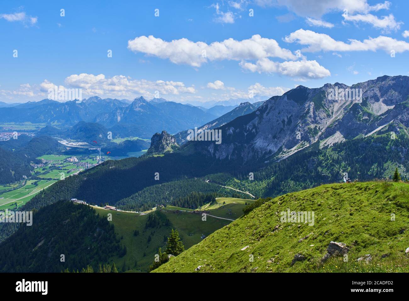 Pfronten, Germany, 28th July 2020, Hiker, mountain biker and paraglider ...