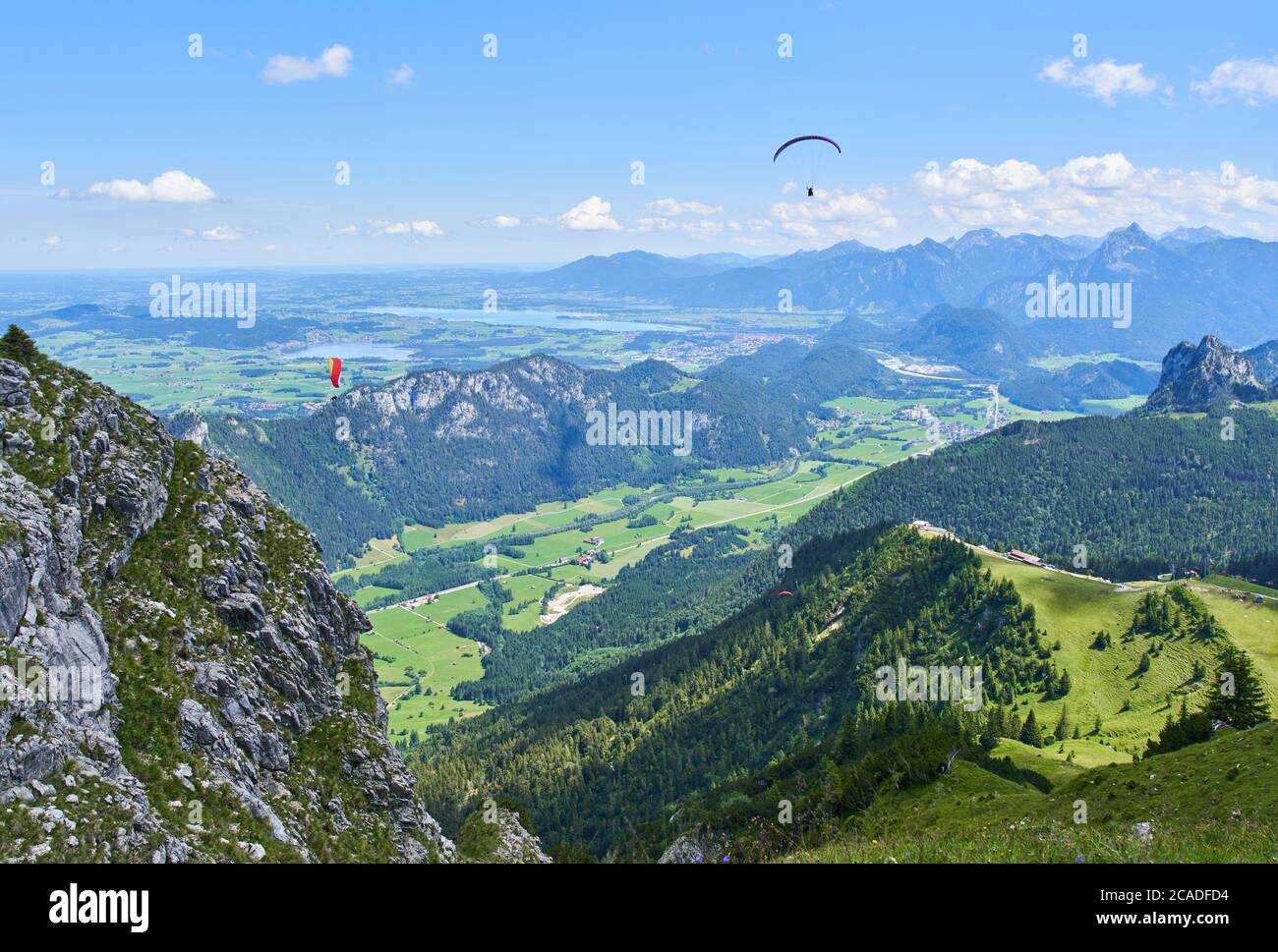 Pfronten, Germany, 28th July 2020, Hiker, mountain biker and paraglider ...