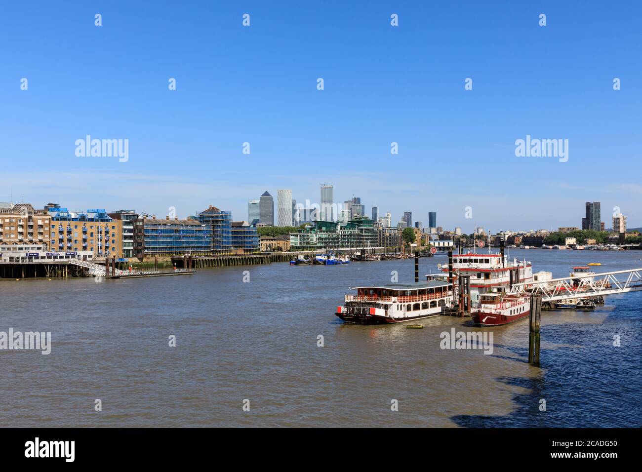The River Thames at Wapping with riverboats, sunshine and summer blue ...