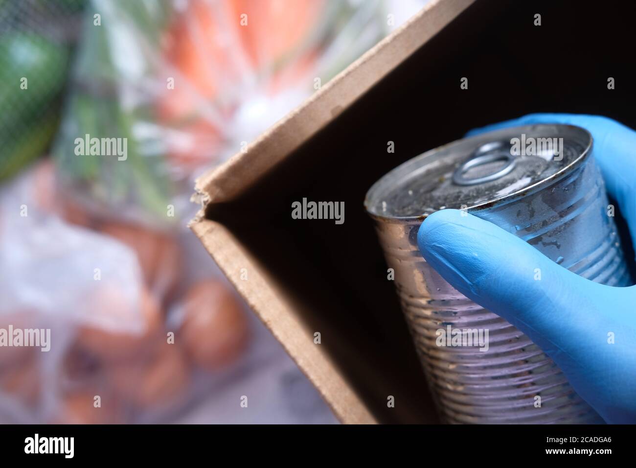 Door delivery of goods. Order picker packing foods in a cardboard boxes ...
