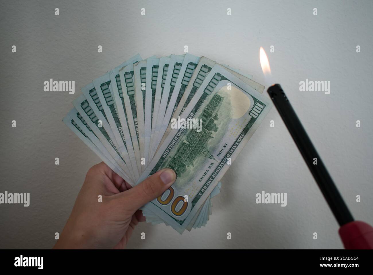 Burning dollars hi-res stock photography and images - Alamy