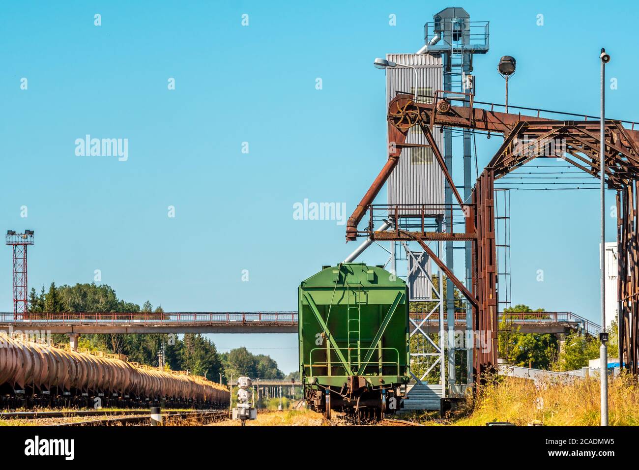Loading railway wagon standing near the elevator in agriculture zone ...