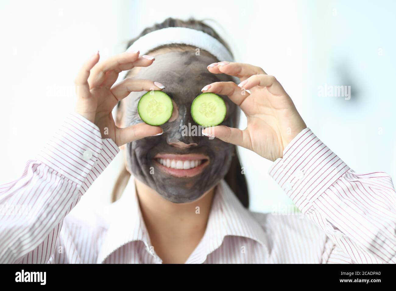 Laughing woman with a cosmetic mask on her face Stock Photo - Alamy