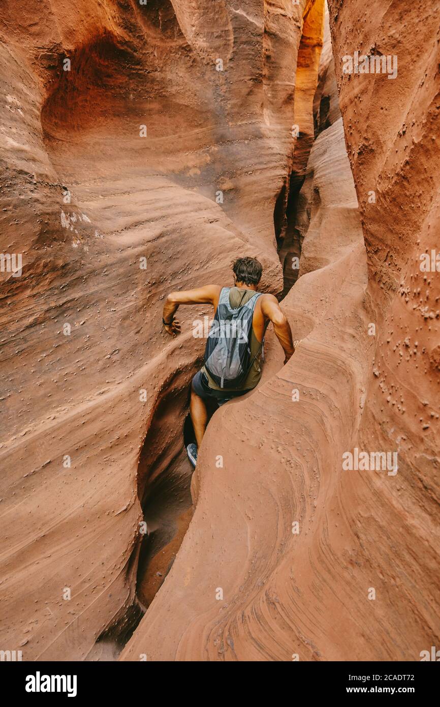 Young man exploring narrow slot canyons in Escalante, during summer Stock Photo - Alamy