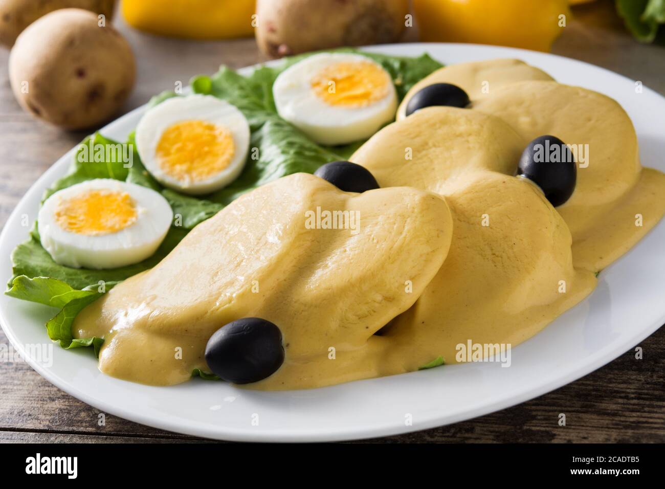 Traditional Peruvian papa a la huancaina on wooden table Stock Photo ...