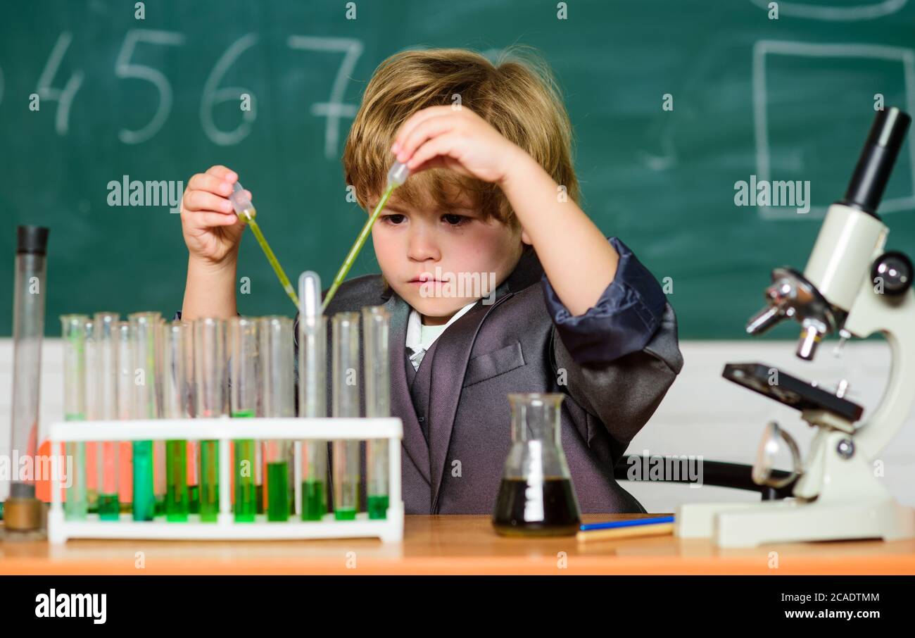 small boy at science camp. microscope at lab. Scientific experiment ...