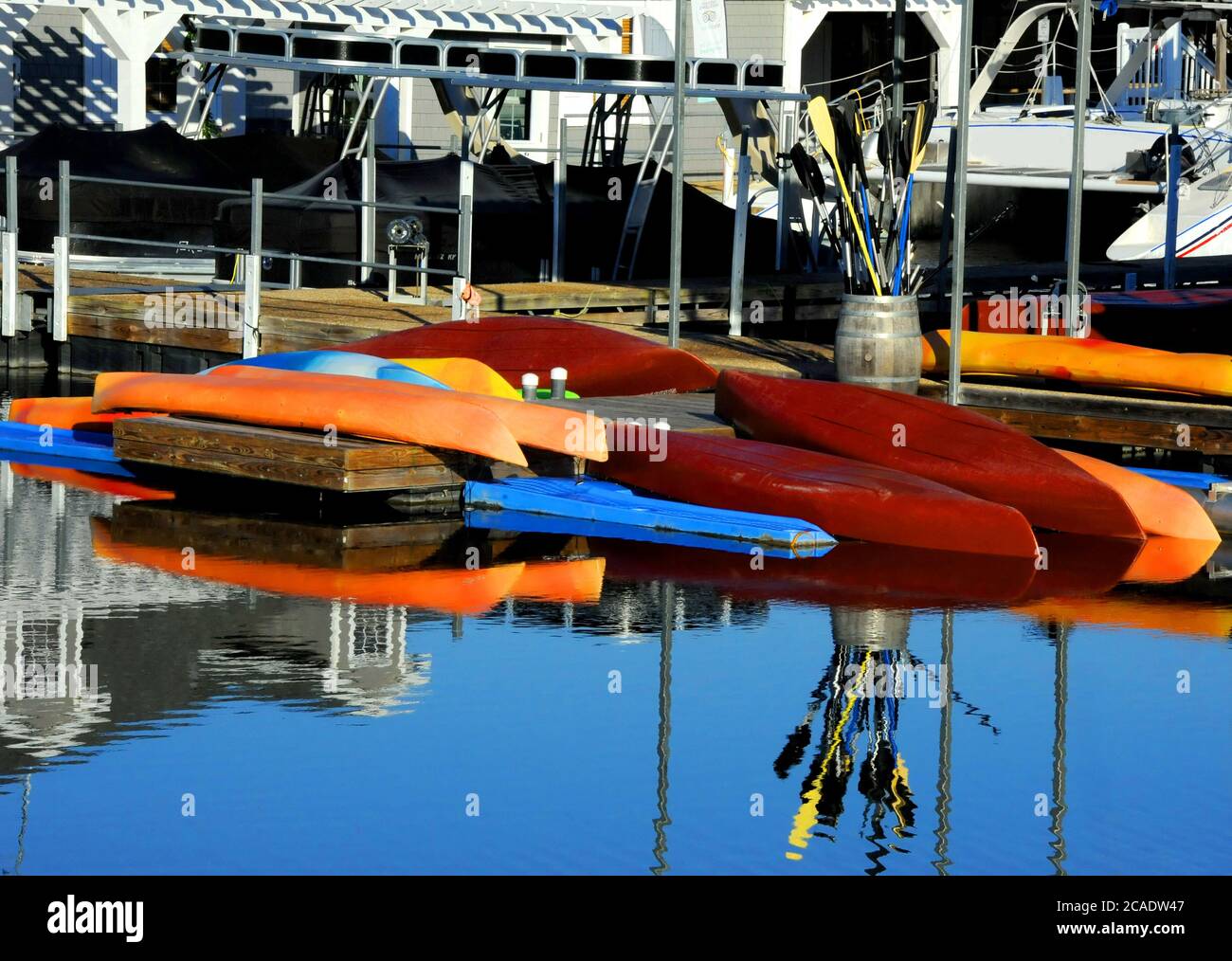 Canoes, boats and oars make for a colorful dispaly at the Marina at ...