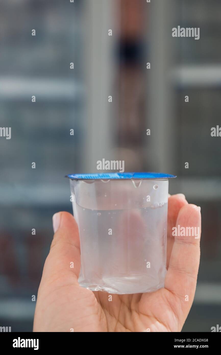 Disposable Turkish eco glass of clean water in a plastic bag ...