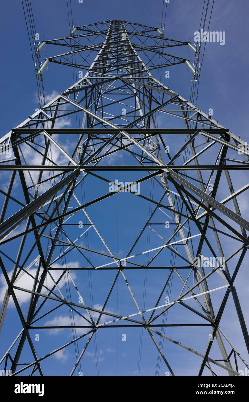 Electricity pylon against bright blue sky, angle view from below. Hoath ...