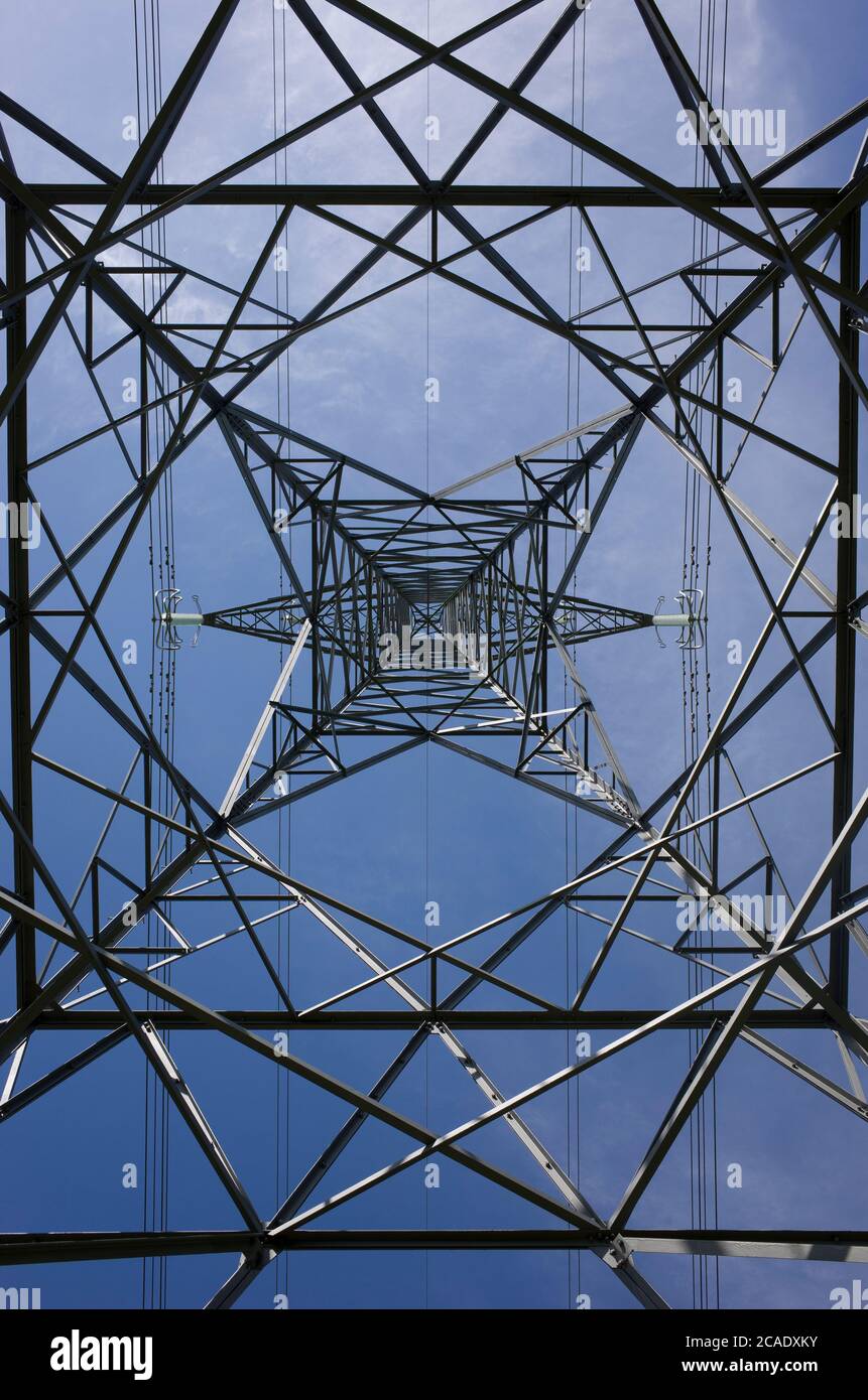Electricity pylon against bright blue sky, angle view from below. Hoath ...