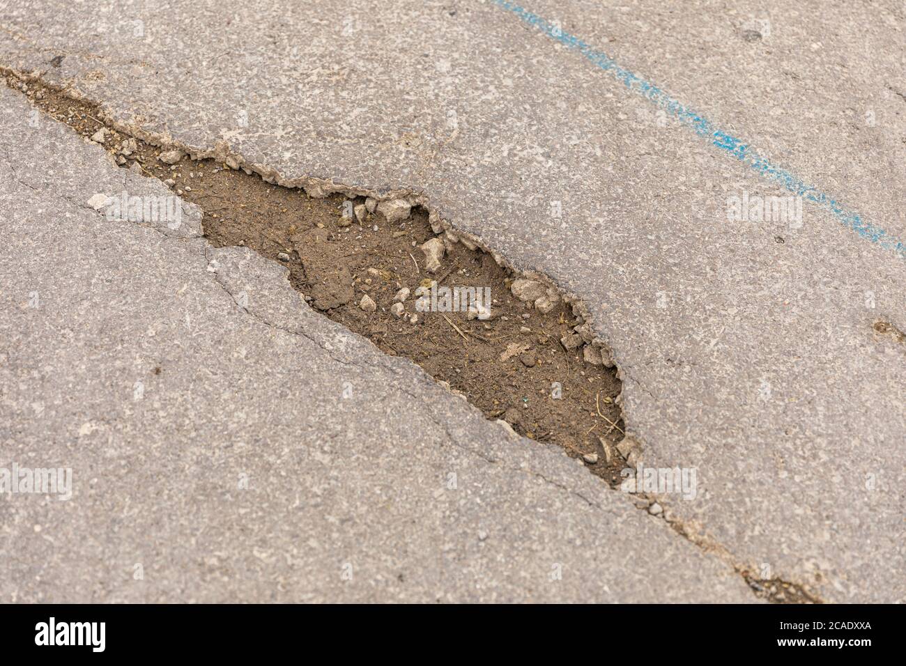 High angle view of old rough asphalt with cracks under the sunlight ...