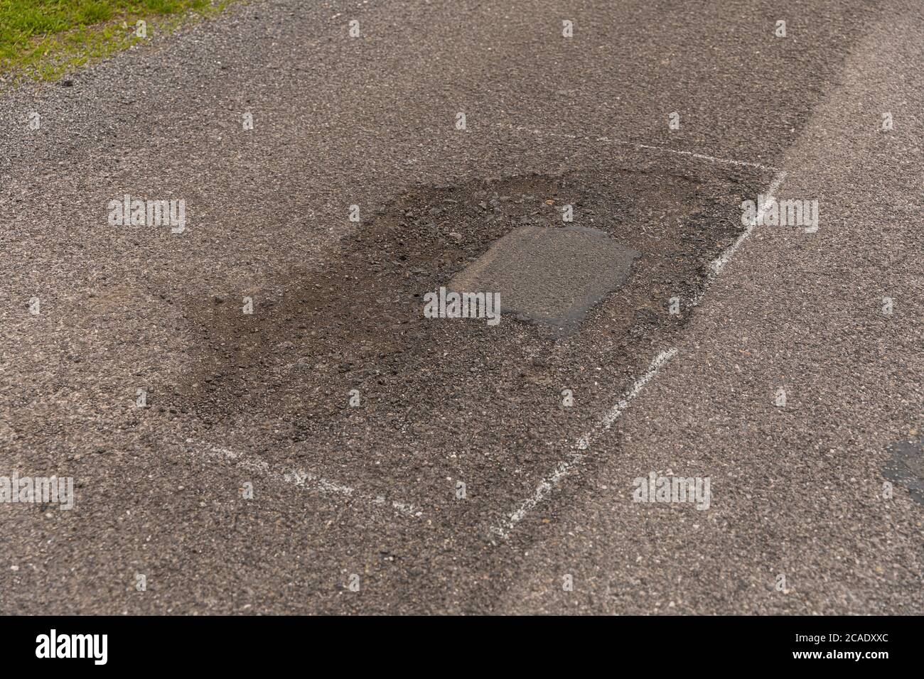 High angle view of old rough asphalt with cracks under the sunlight ...