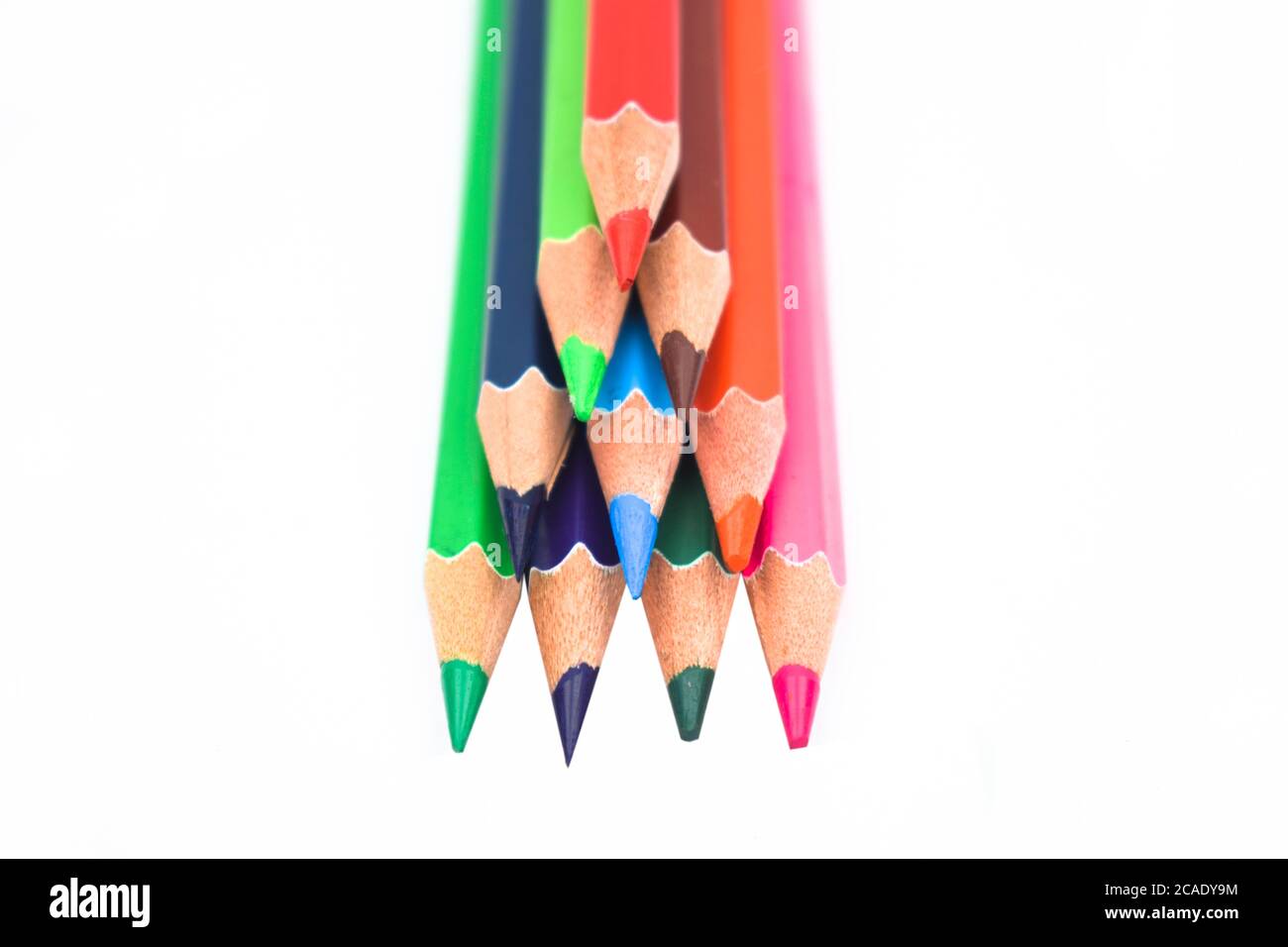 Pyramid shape made with some different colored wood pencil crayons on a ...