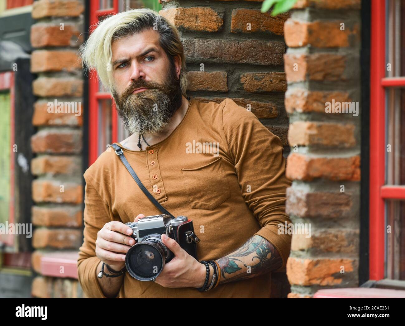 search for inspiration. hipster man with beard use professional camera ...