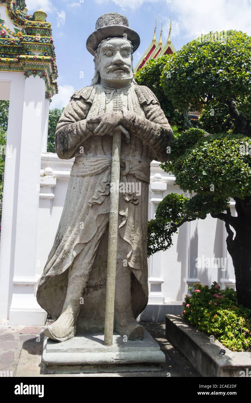 Solitary Chinese stone guardian statue next to door at the Wat Pho ...