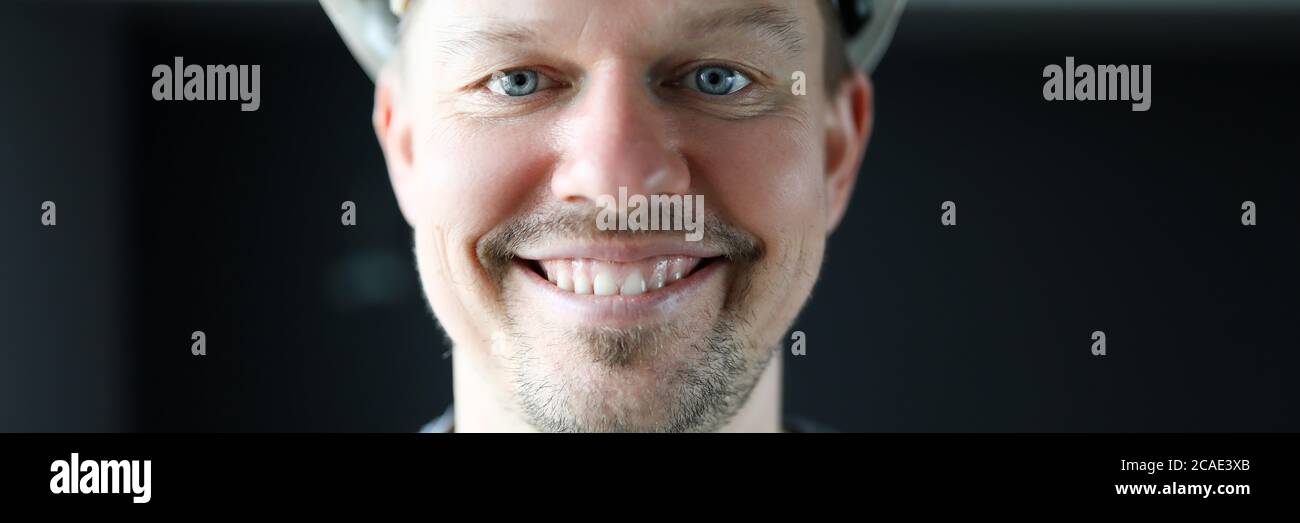 Happy builder man in helmet stands in apartment Stock Photo - Alamy