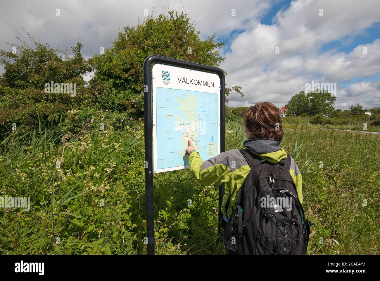 A tourist looking at a map sign in Vrango Island, Gothenburg ...
