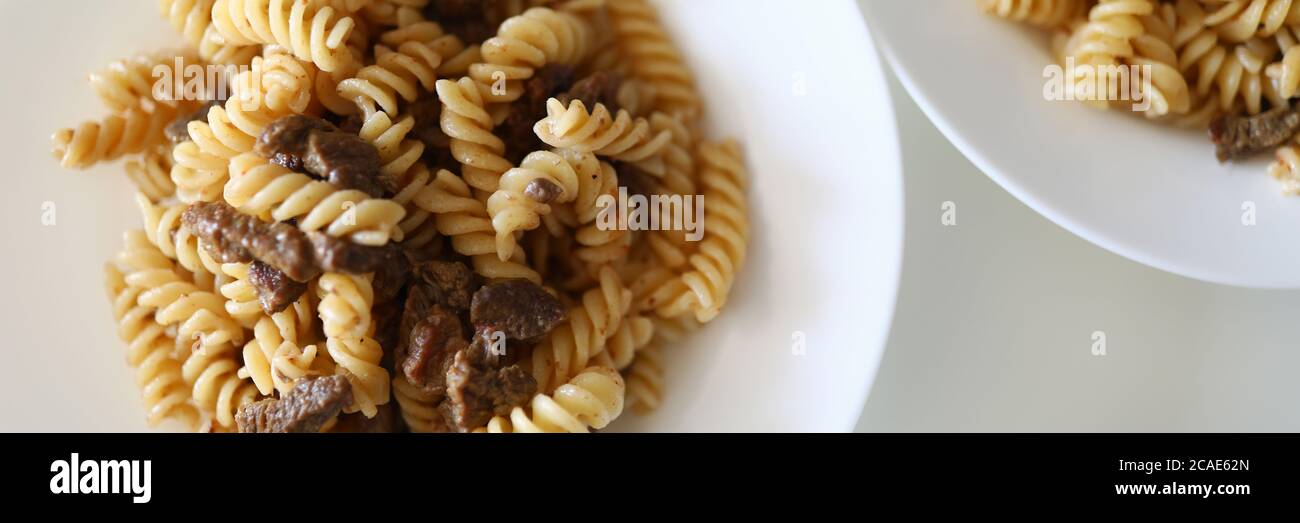 On table is plate cooked delicious pasta and meat Stock Photo - Alamy